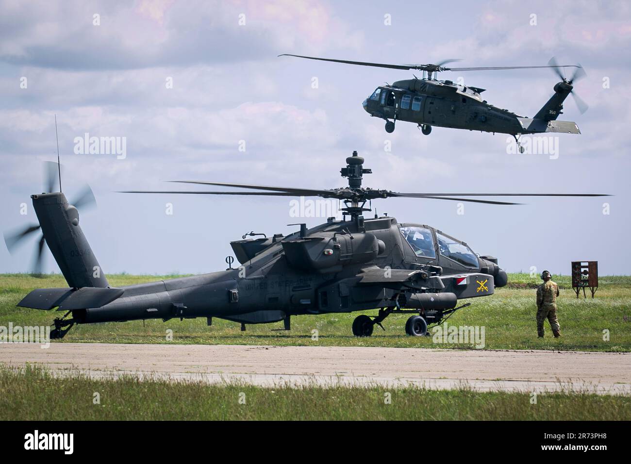 A UH-60 Blackhawk helicopter prepares to land at the airfield with an ...