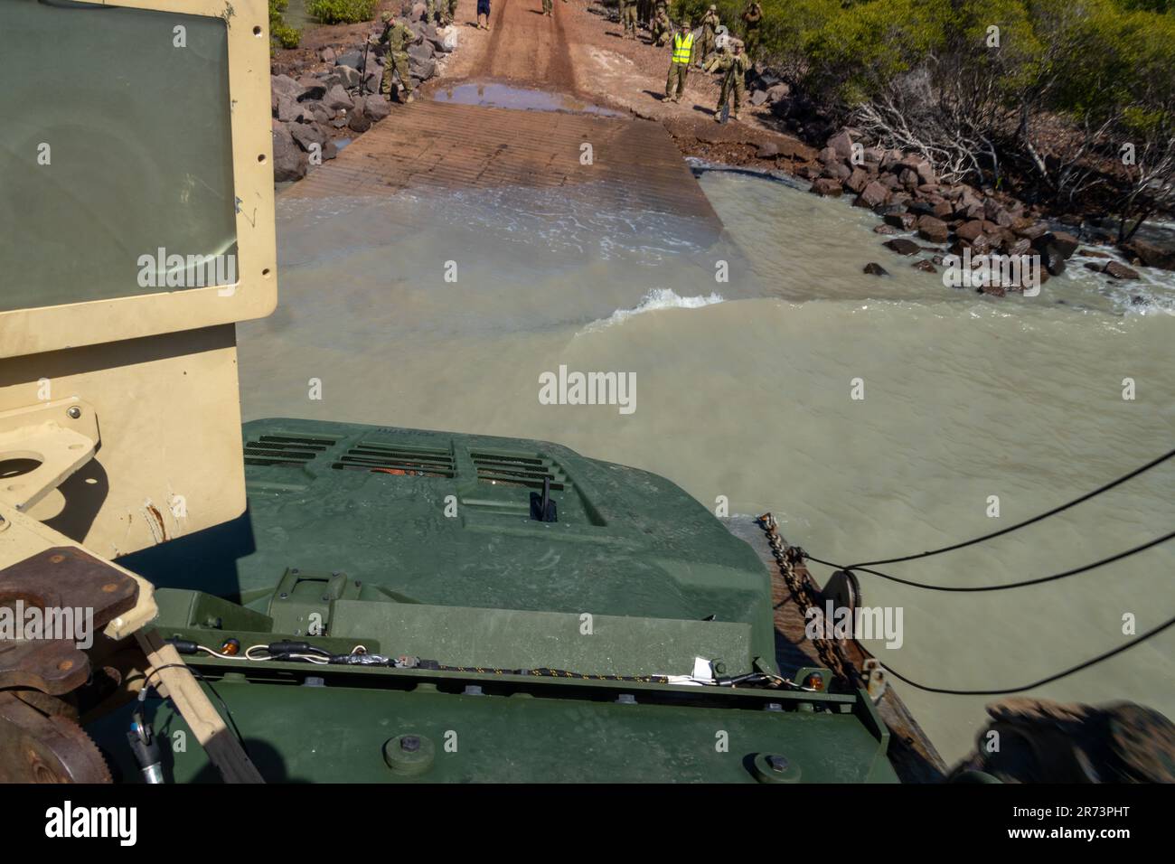 A Joint Light Tactical Vehicle drives ashore from landing craft Centaur ...