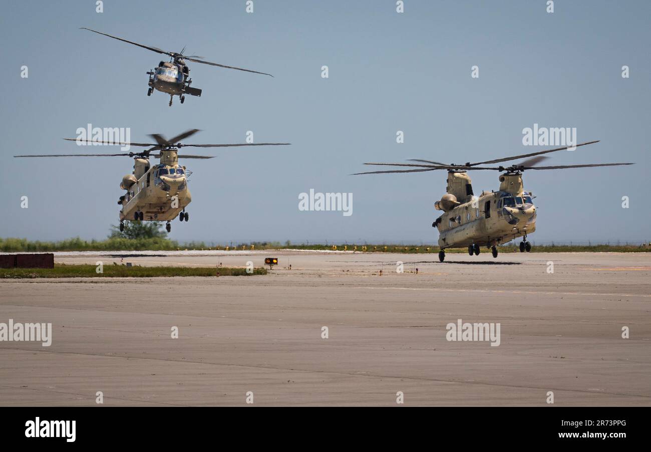 A UH-60 Black Hawk and two CH-47 Chinook helicopters land at Mihail ...