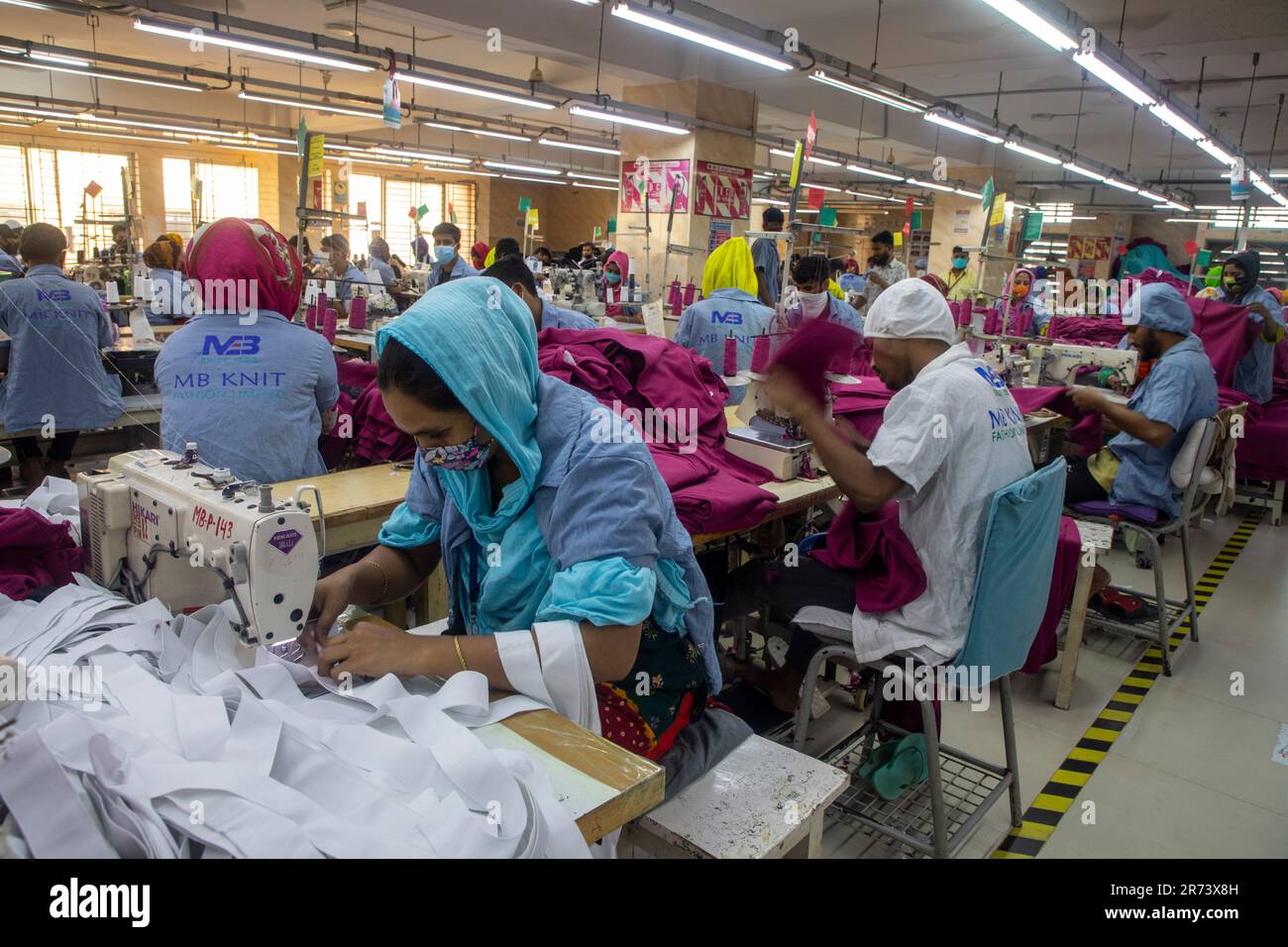 Ready-made garments (RMG) workers working in a factory at Fatullah in ...