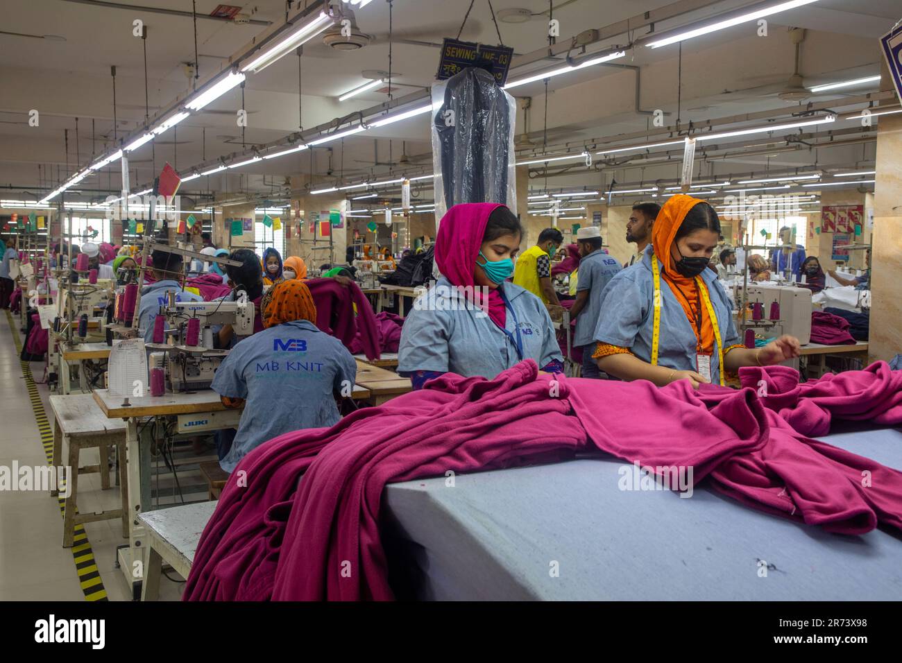 Ready-made garments (RMG) workers working in a factory at Fatullah in ...