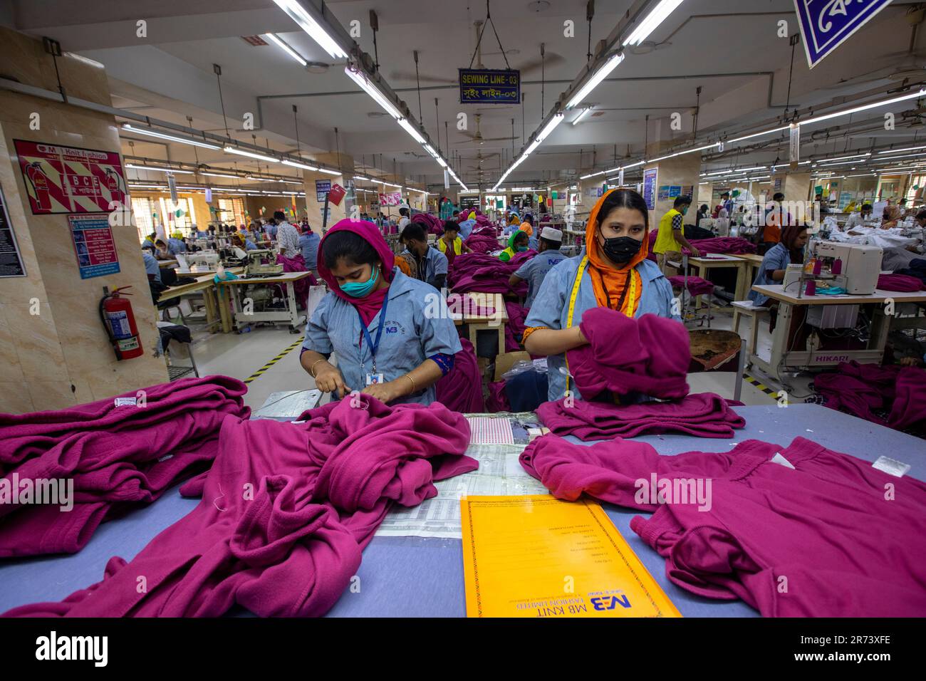 Ready-made garments (RMG) workers working in a factory at Fatullah in Narayanganj, Bangladesh ...
