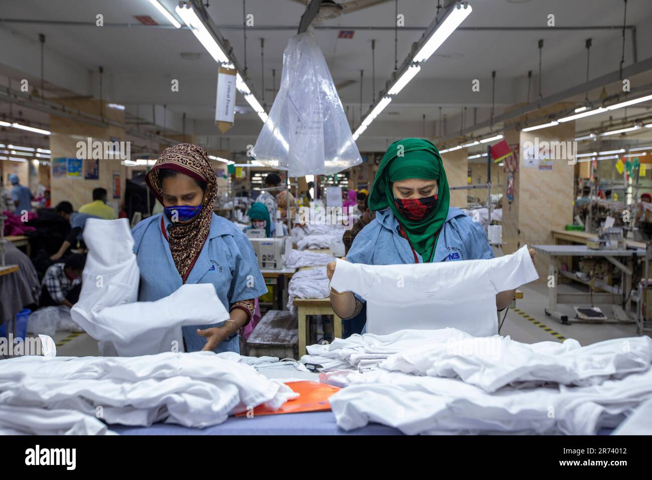 Ready-made garments (RMG) workers working in a factory at Fatullah in ...