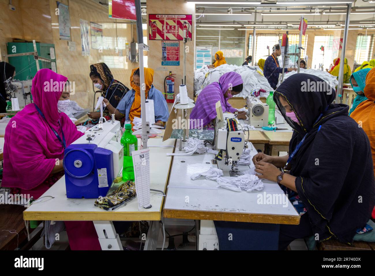 Ready-made garments (RMG) workers working in a factory at Fatullah in ...