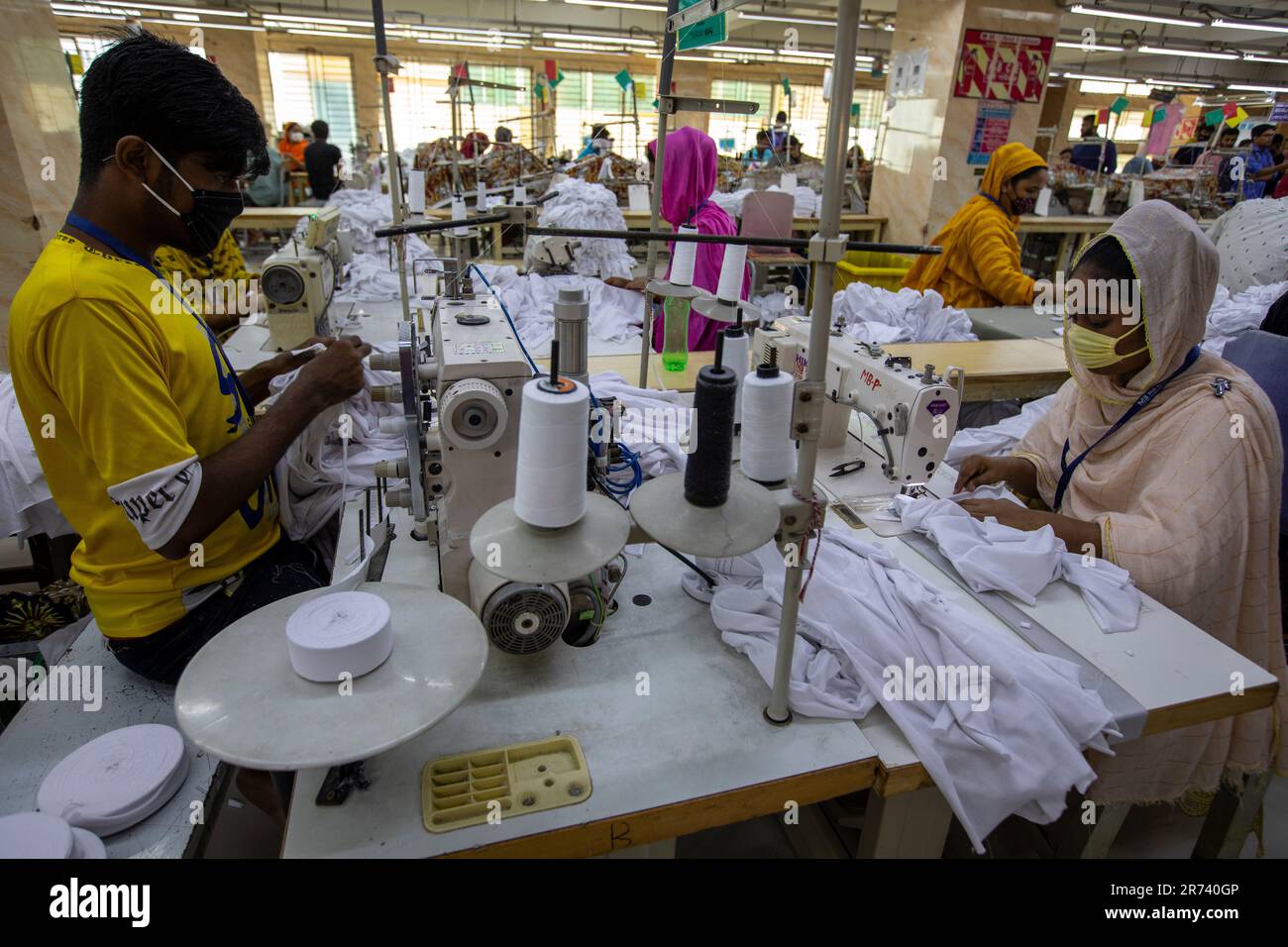 Ready-made garments (RMG) workers working in a factory at Fatullah in ...