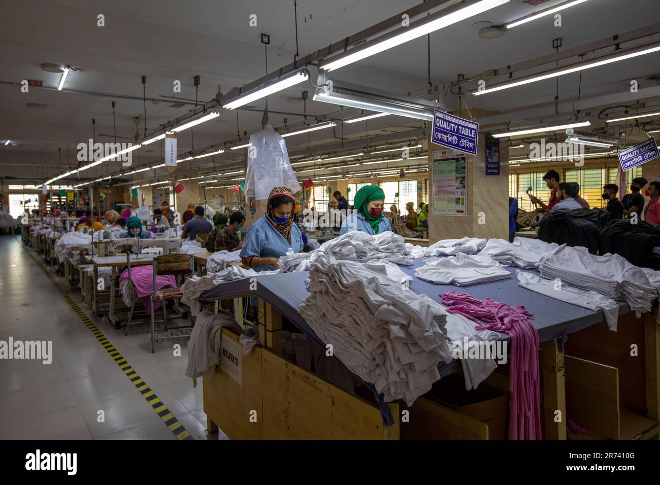Ready-made garments (RMG) workers working in a factory at Fatullah in ...
