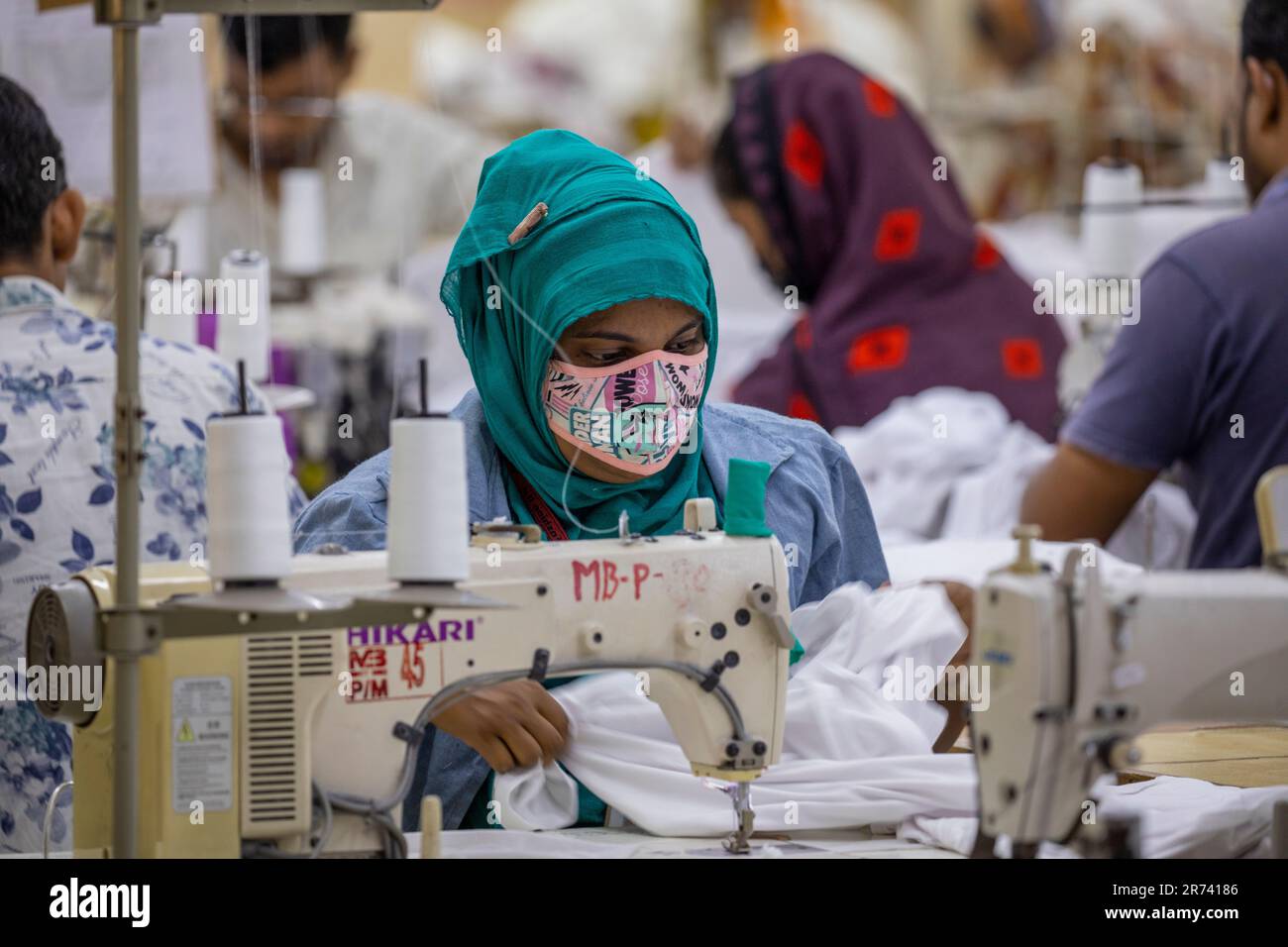 Ready-made garments (RMG) workers working in a factory at Fatullah in ...