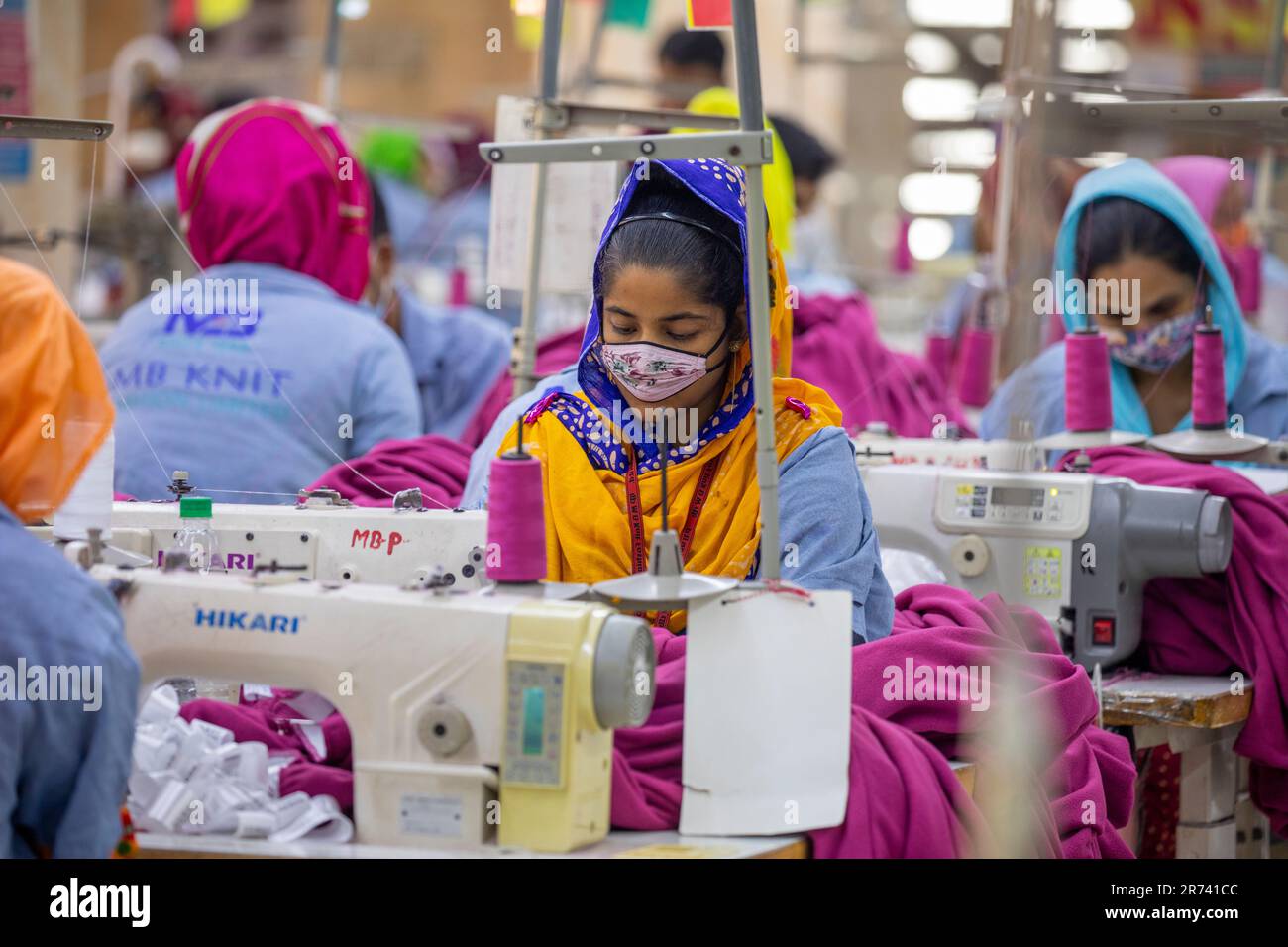 Ready-made garments (RMG) workers working in a factory at Fatullah in ...