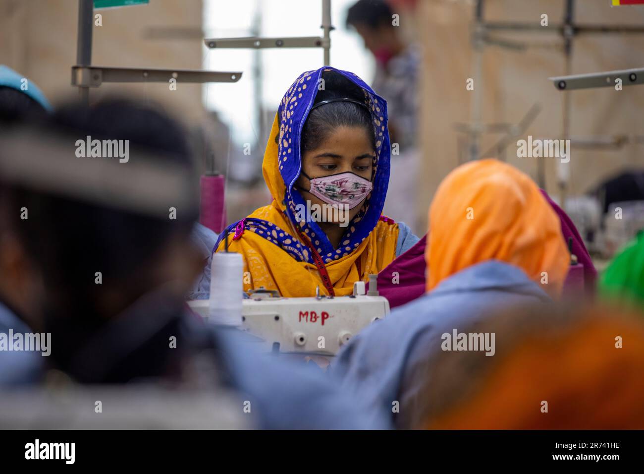 A ready-made garments (RMG) worker working in a factory at Fatullah in ...
