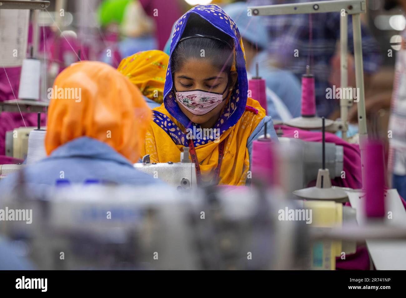 A ready-made garments (RMG) worker working in a factory at Fatullah in ...