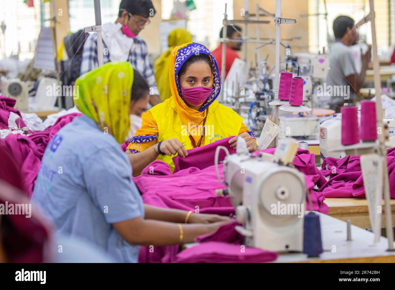 Ready-made garments (RMG) workers working in a factory at Fatullah in ...