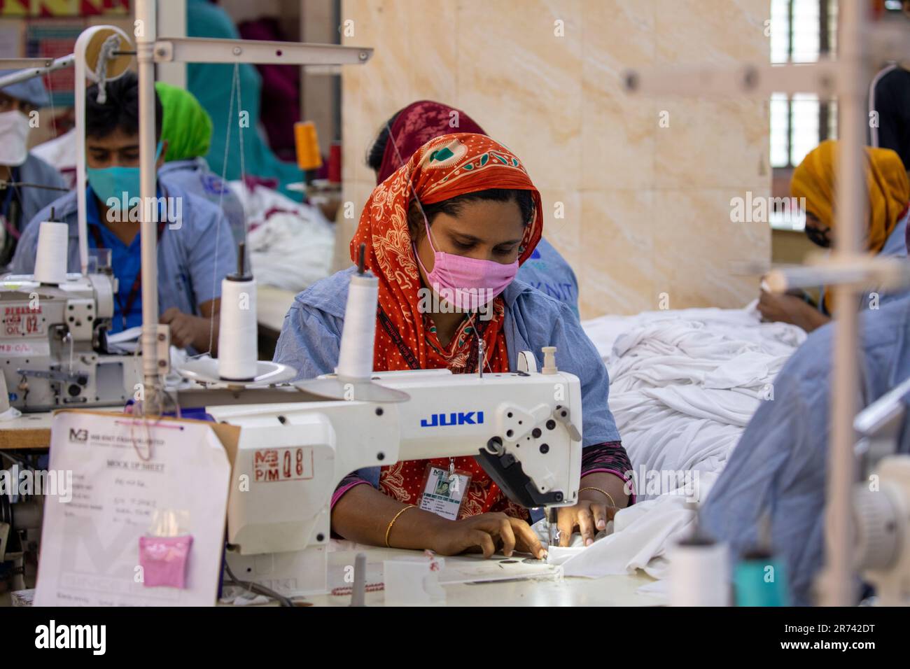 Ready-made garments (RMG) workers working in a factory at Fatullah in ...
