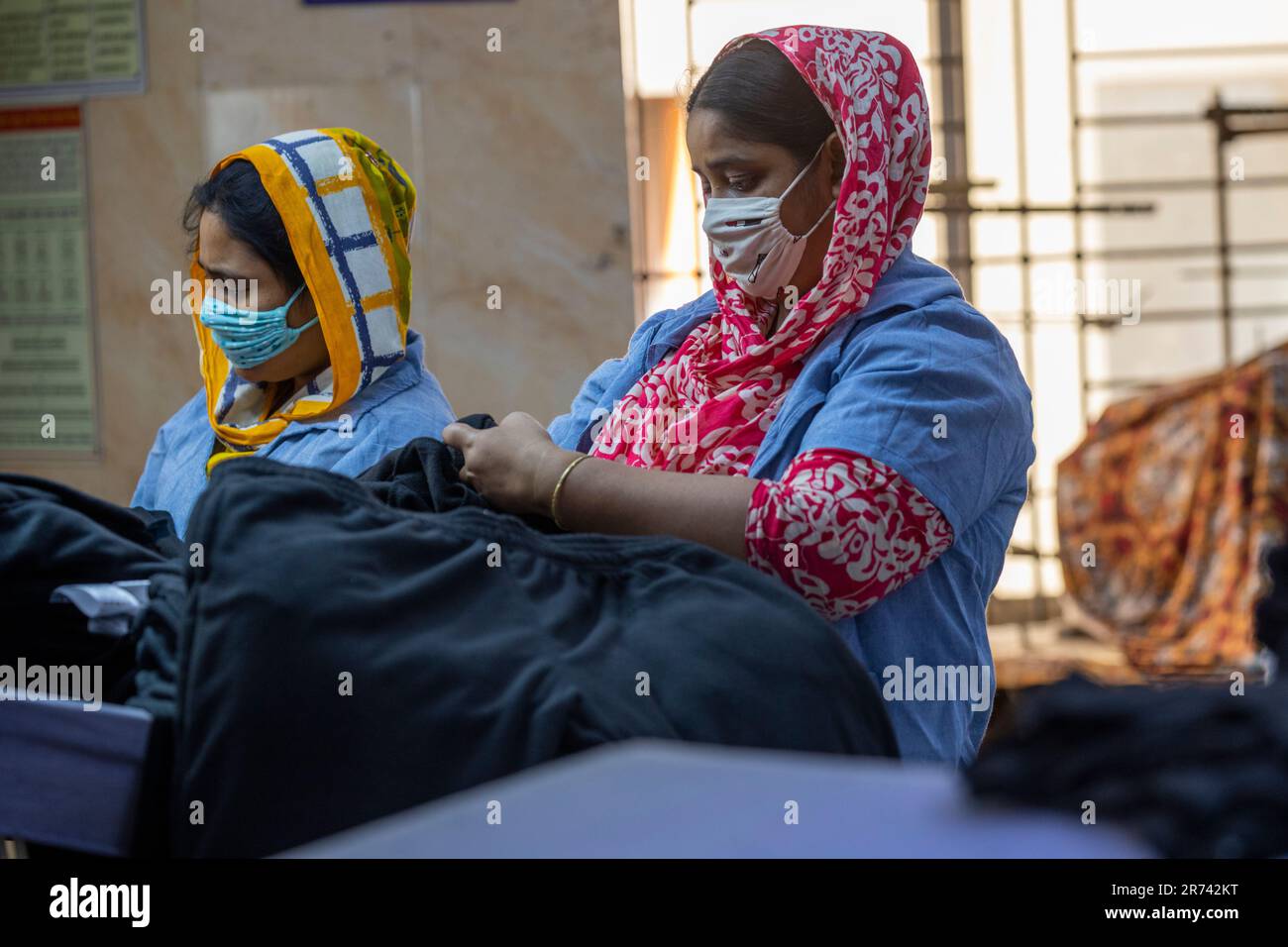 Ready-made garments (RMG) workers working in a factory at Fatullah in ...