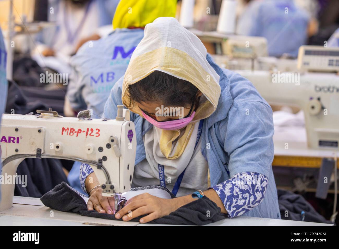 A ready-made garments (RMG) worker working in a factory at Fatullah in ...