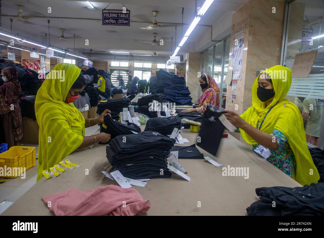 Ready-made garments (RMG) workers working in a factory at Fatullah in ...