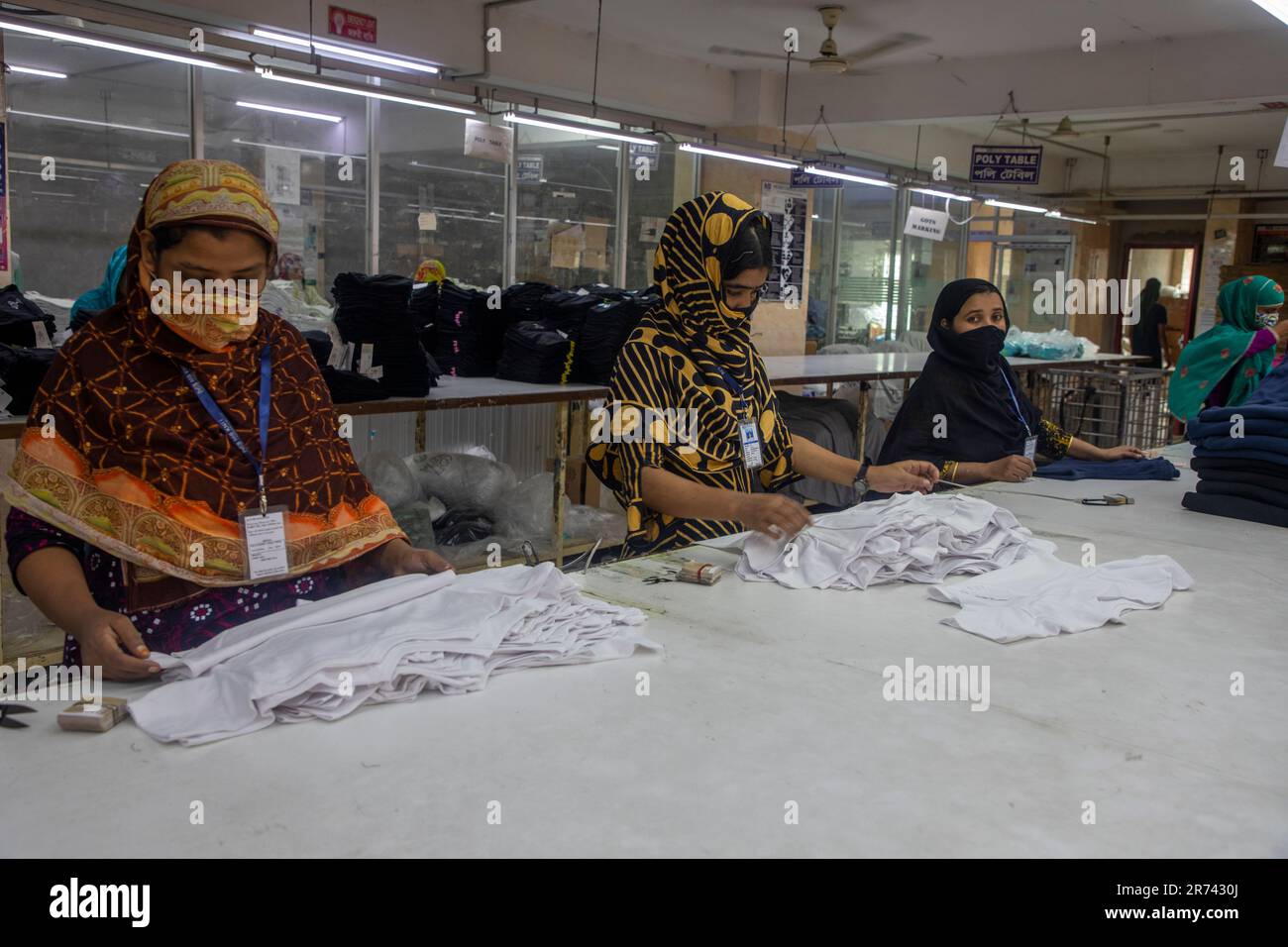 Ready-made garments (RMG) workers working in a factory at Fatullah in ...