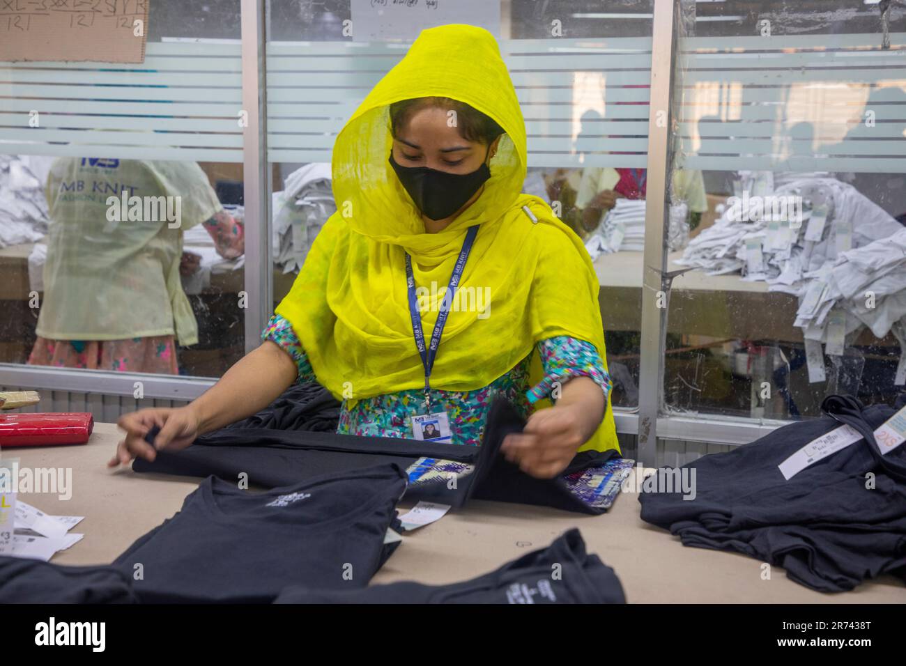 A ready-made garments (RMG) worker working in a factory at Fatullah in ...