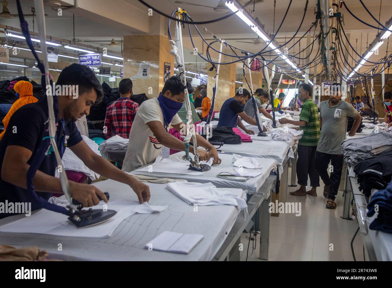 Ready-made garments (RMG) workers working in a factory at Fatullah in ...