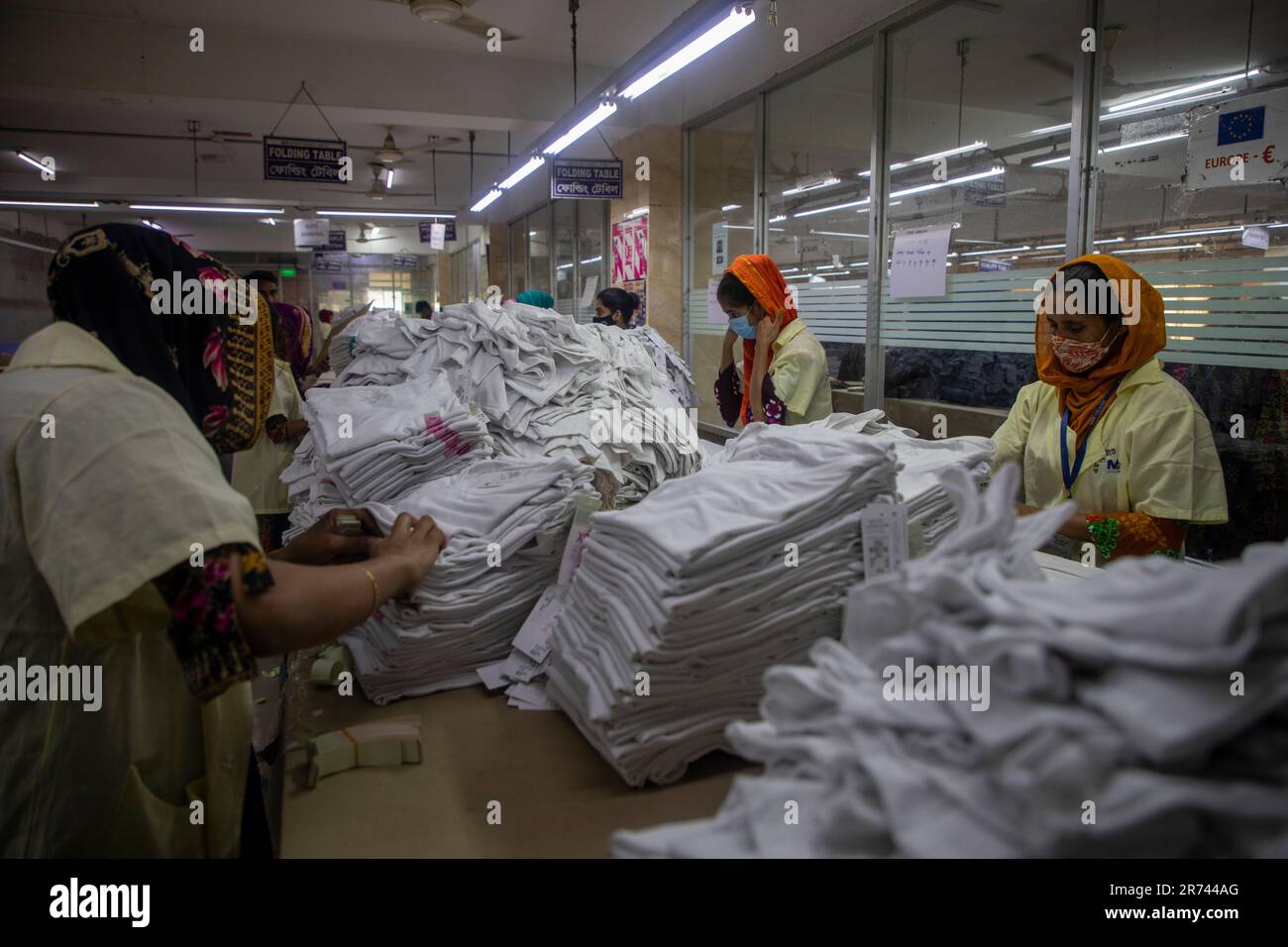 Ready-made garments (RMG) workers working in a factory at Fatullah in ...