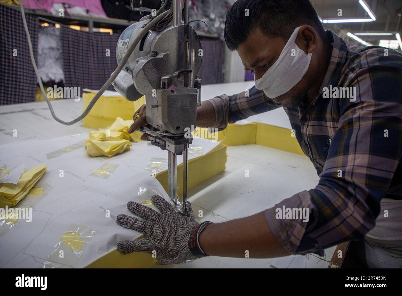 A ready-made garments (RMG) worker working in a factory at Fatullah in ...