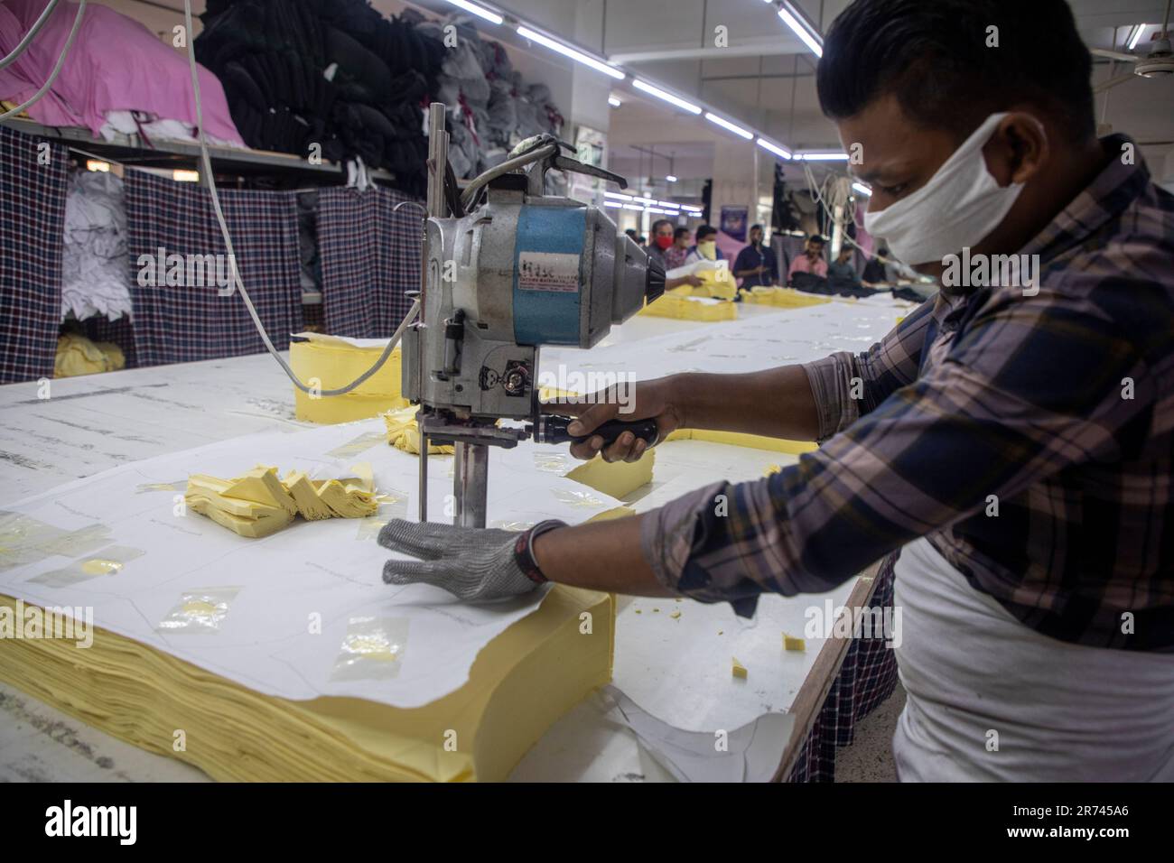 A ready-made garments (RMG) worker working in a factory at Fatullah in ...