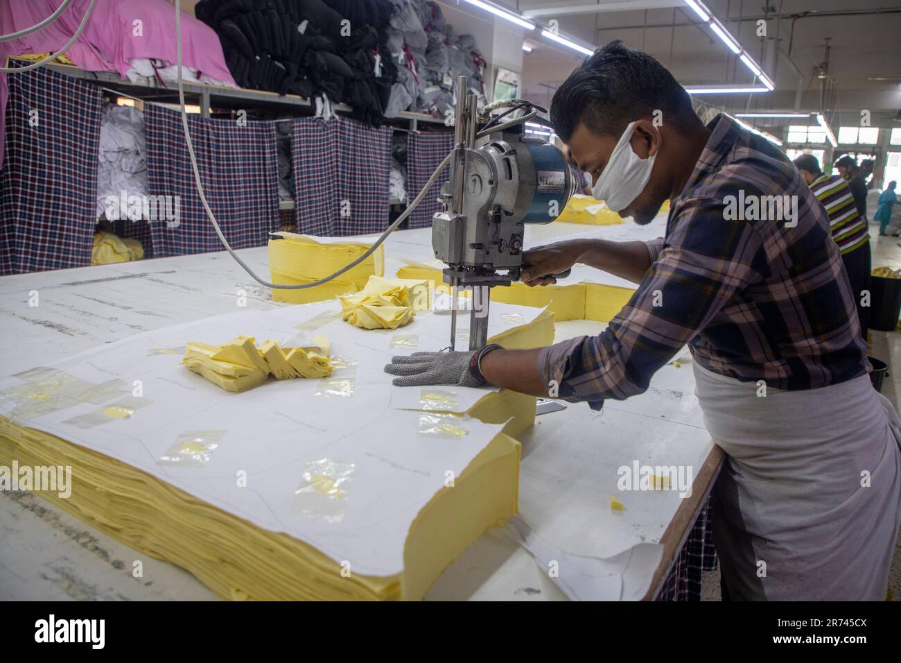 A ready-made garments (RMG) worker working in a factory at Fatullah in ...