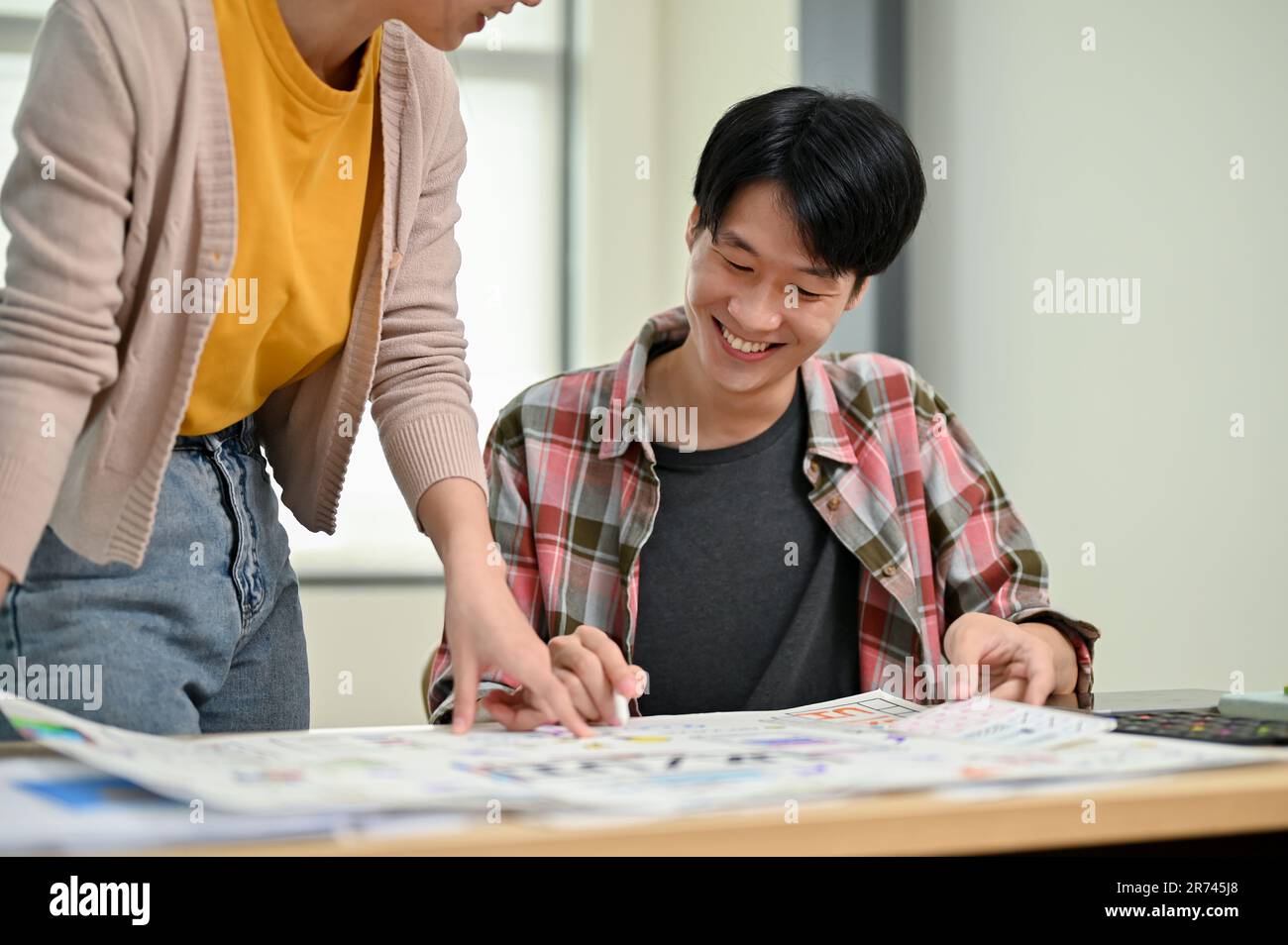 A handsome and smart young Asian male developer enjoys working and ...