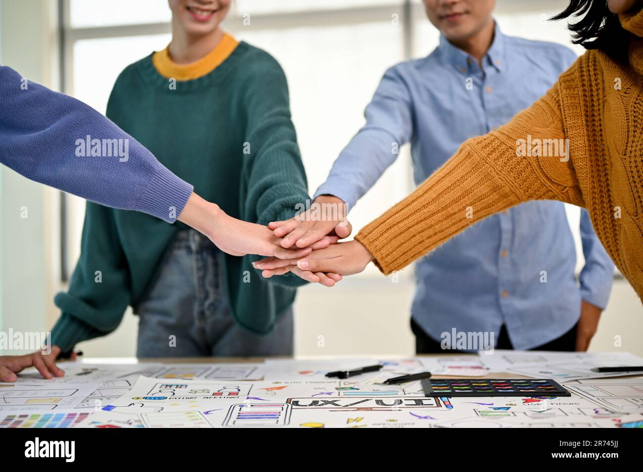 A close-up image of a team of developers or graphic designers putting ...