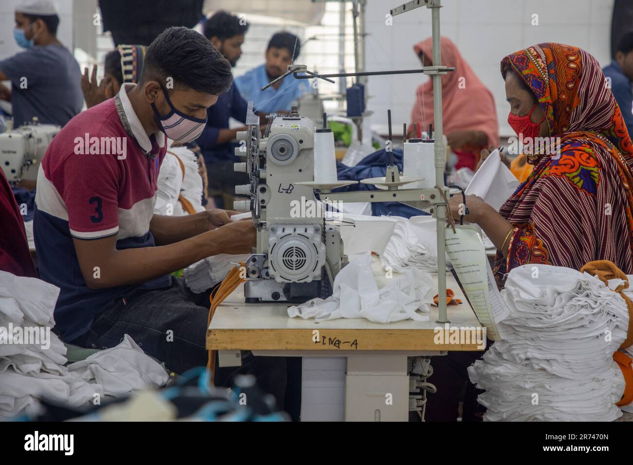 Ready-made garments (RMG) workers working in a factory at Fatullah in ...