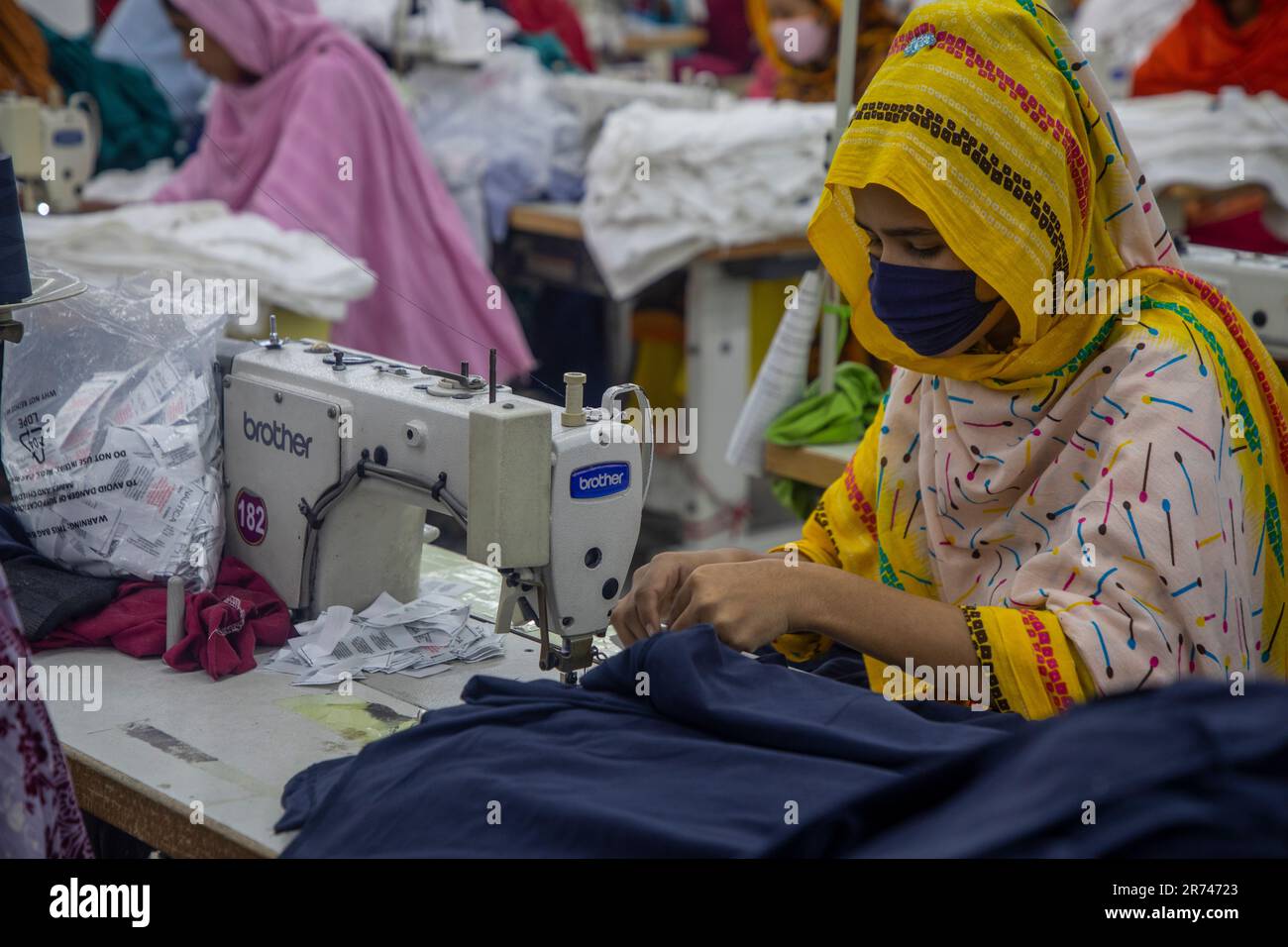 Ready-made garments (RMG) workers working in a factory at Fatullah in ...