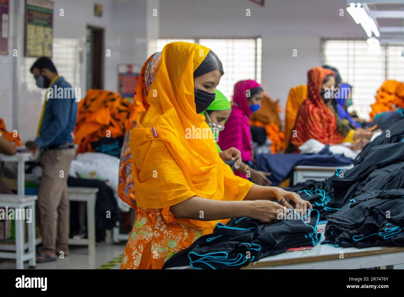 Ready-made garments (RMG) workers working in a factory at Fatullah in ...