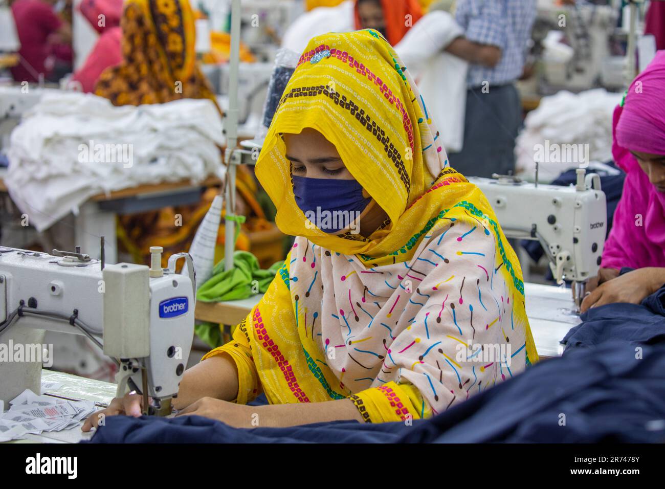 Ready-made garments (RMG) workers working in a factory at Fatullah in ...