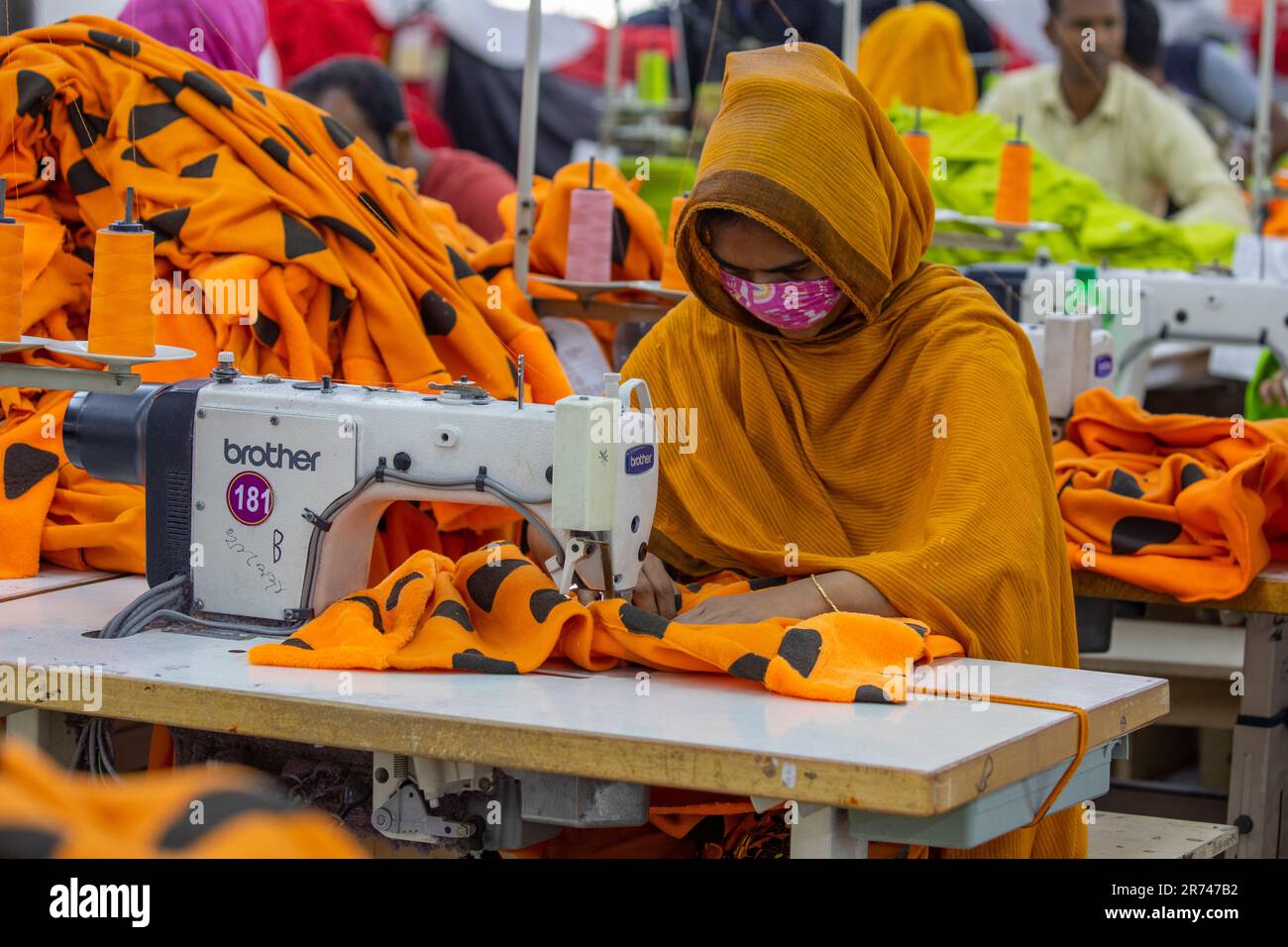Ready-made garments (RMG) workers working in a factory at Fatullah in ...