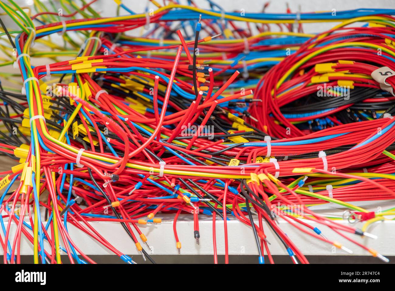 The bunch of electric wires or cables are strongly tangled together. Remnants of wires of ...