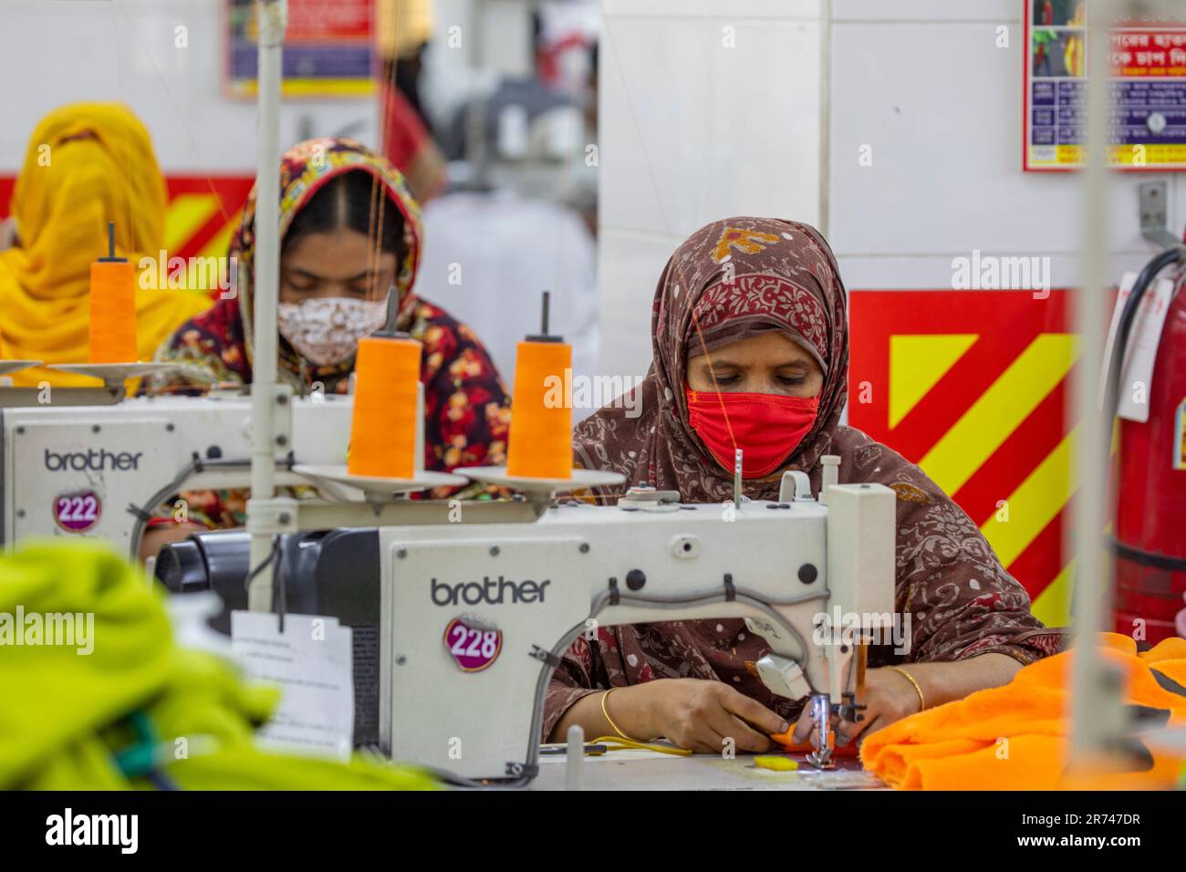 Ready-made garments (RMG) workers working in a factory at Fatullah in ...
