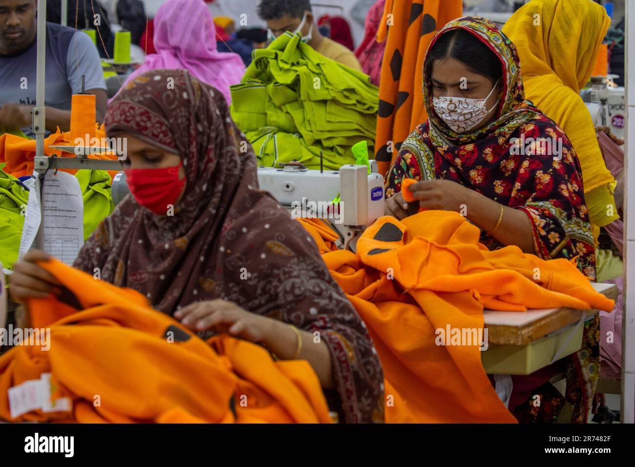 Ready-made garments (RMG) workers working in a factory at Fatullah in ...
