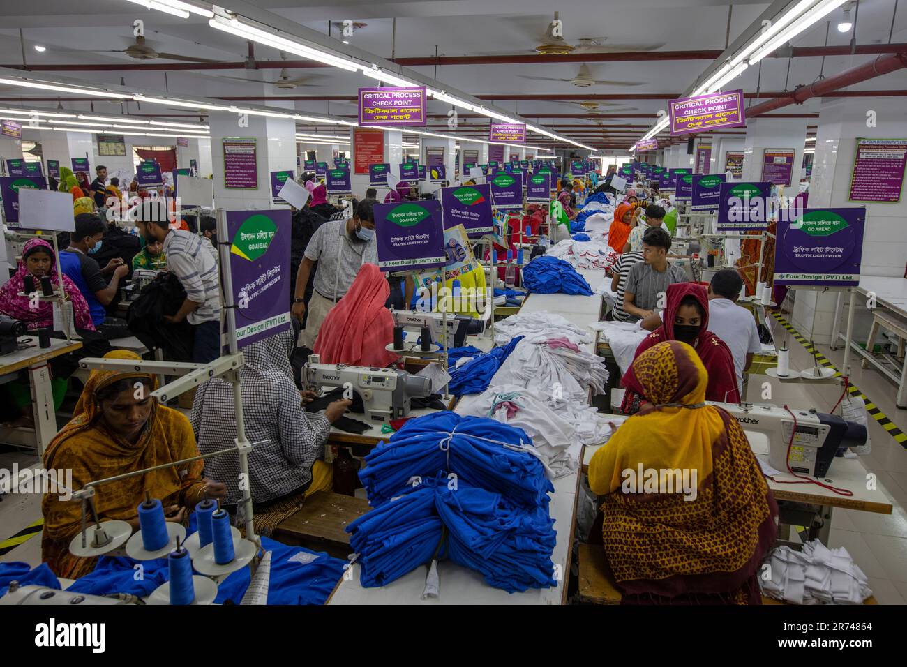 Ready-made garments (RMG) workers working in a factory at Fatullah in ...