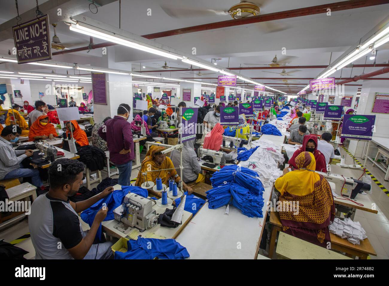 Ready-made garments (RMG) workers working in a factory at Fatullah in ...