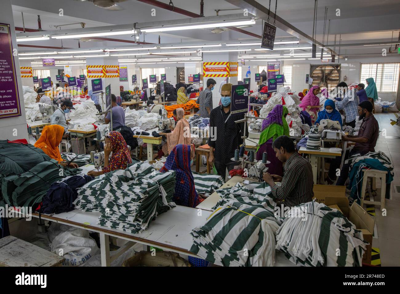 Ready-made garments (RMG) workers working in a factory at Fatullah in ...