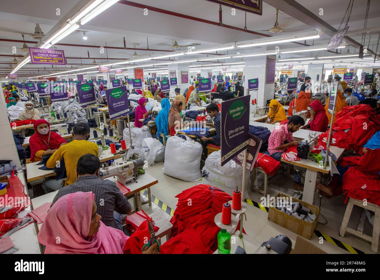Ready-made garments (RMG) workers working in a factory at Fatullah in ...