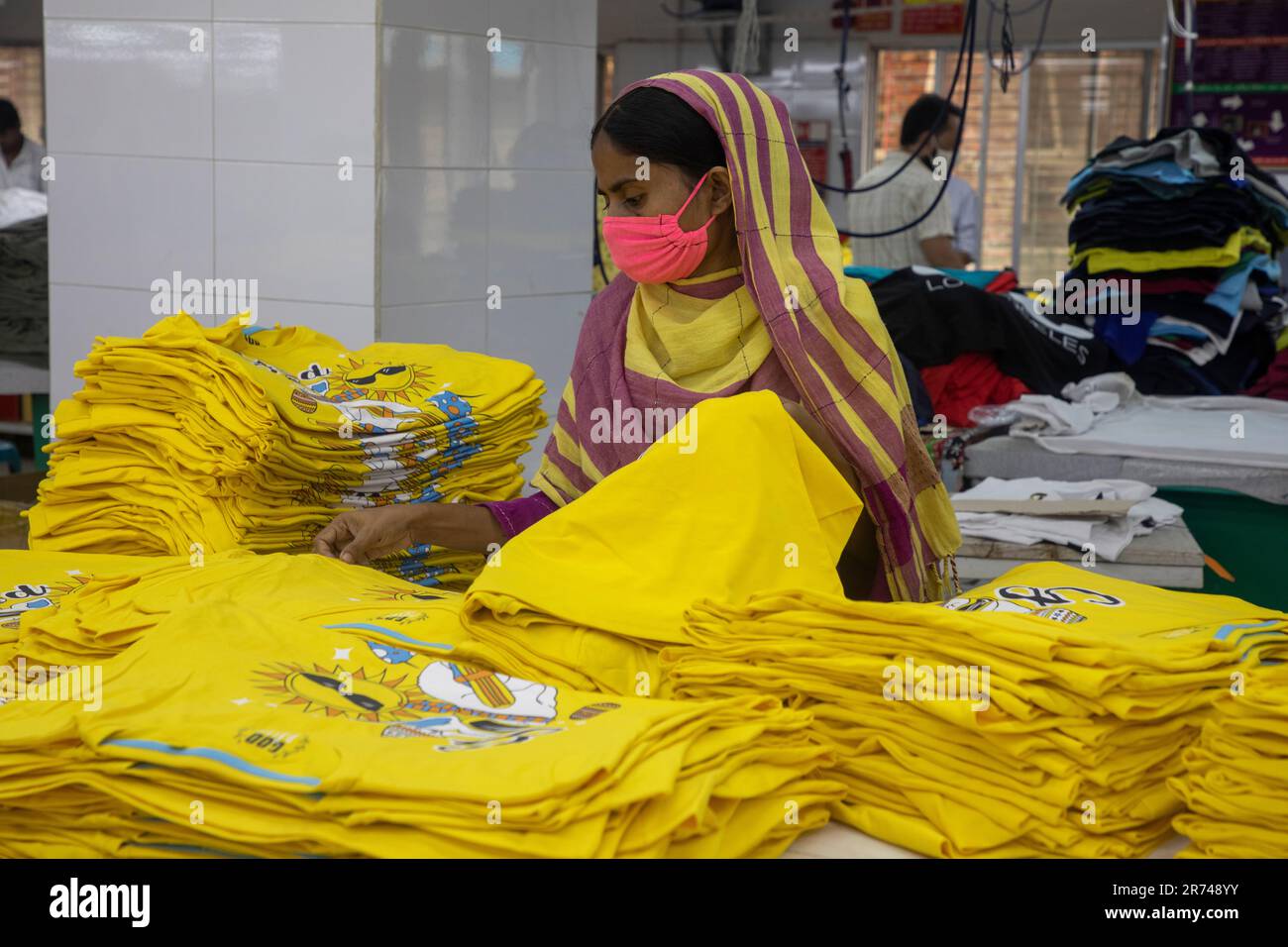 Ready-made garments (RMG) workers working in a factory at Fatullah in ...