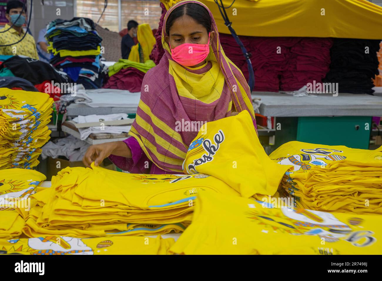 A ready-made garments (RMG) worker working in a factory at Fatullah in ...