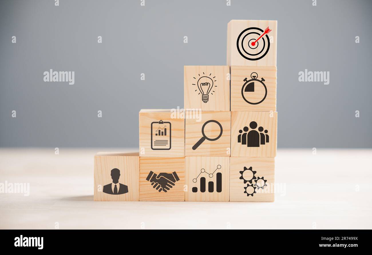 Wooden block cude step on table with Action Plan Stock Photo - Alamy