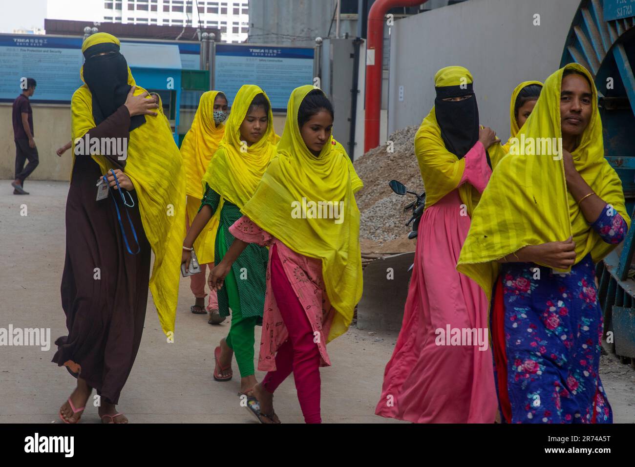 Female workers of a ready-made garment enter in a factory at Fatullah ...