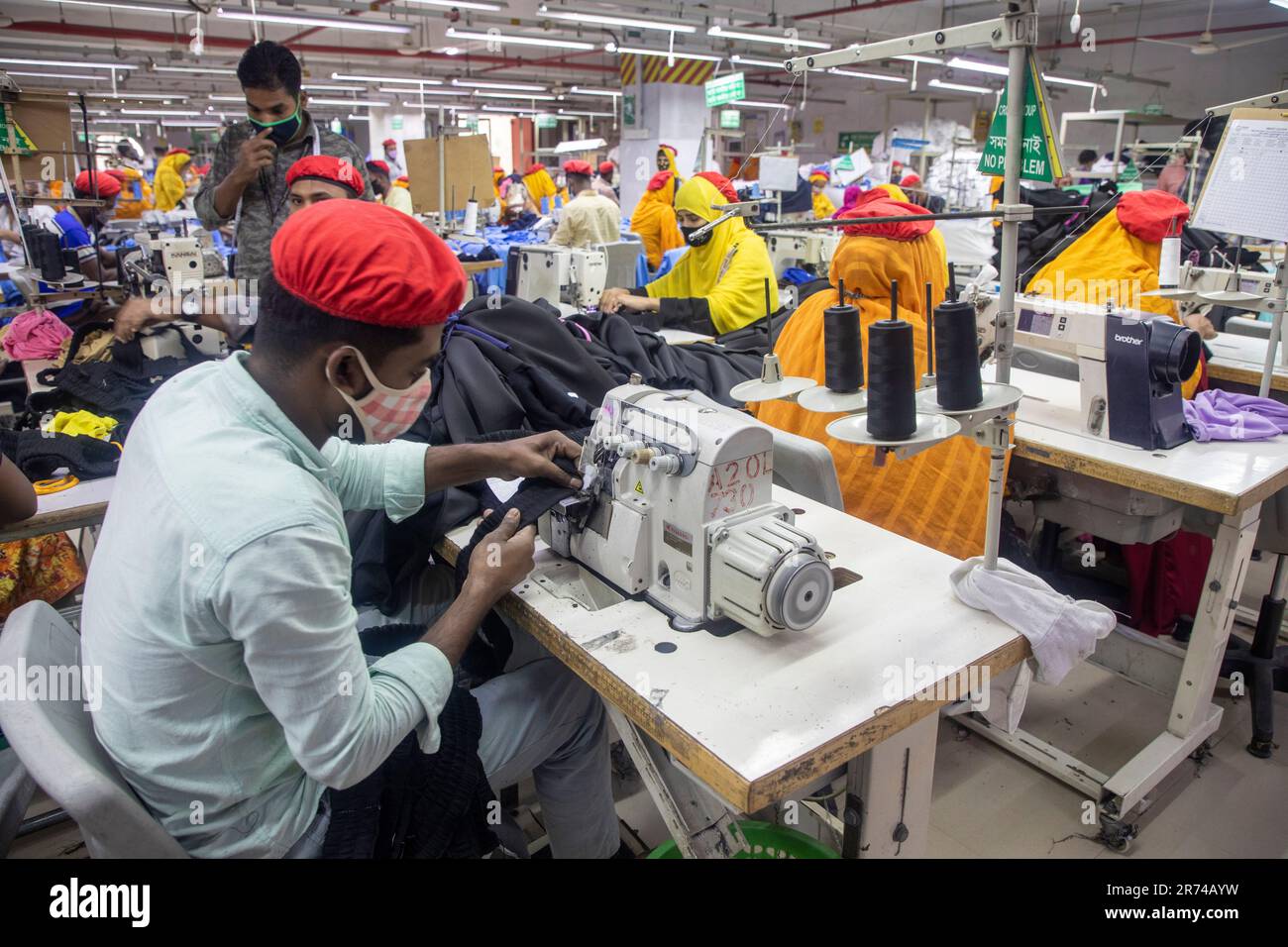 Ready-made garments (RMG) workers working in a factory at Fatullah in ...