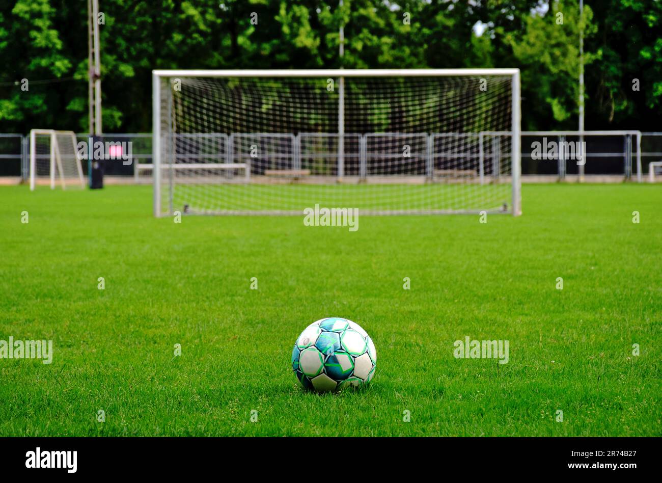 white soccer ball closeup. outdoor green soccer field. lush green grass ...