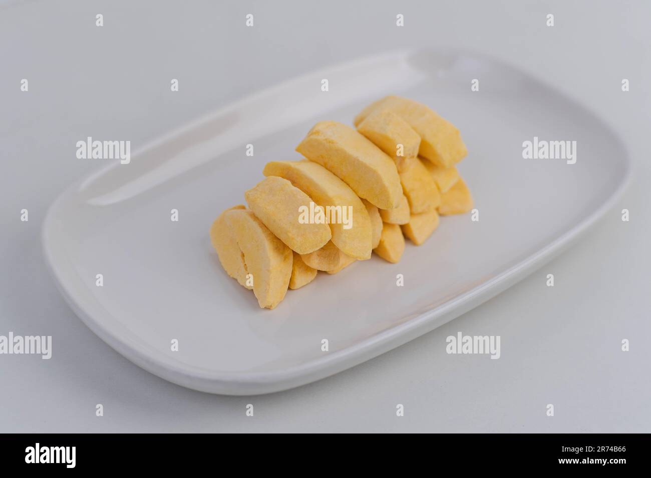 Healthy freeze dried fruits. Freeze-dried mango in plate on table ...