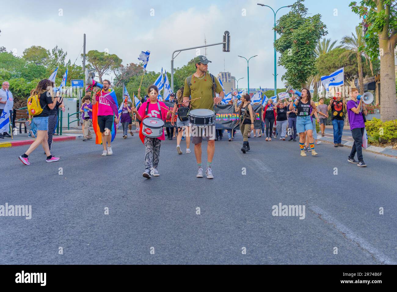 Haifa, Israel - June 10, 2023: People marching with flags and various ...