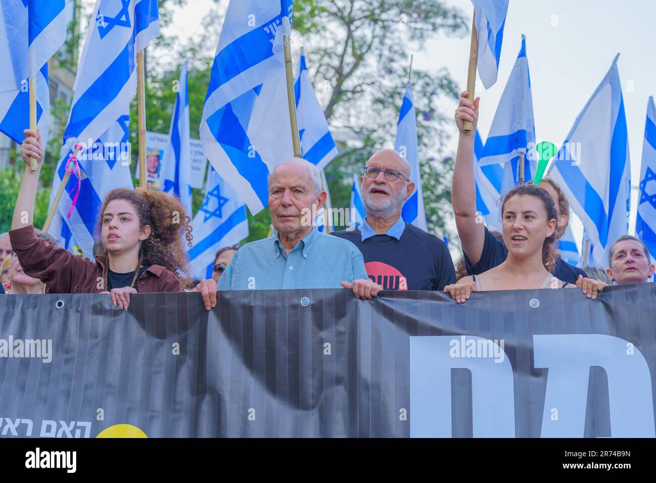 Haifa, Israel - June 10, 2023: People marching with flags and various ...