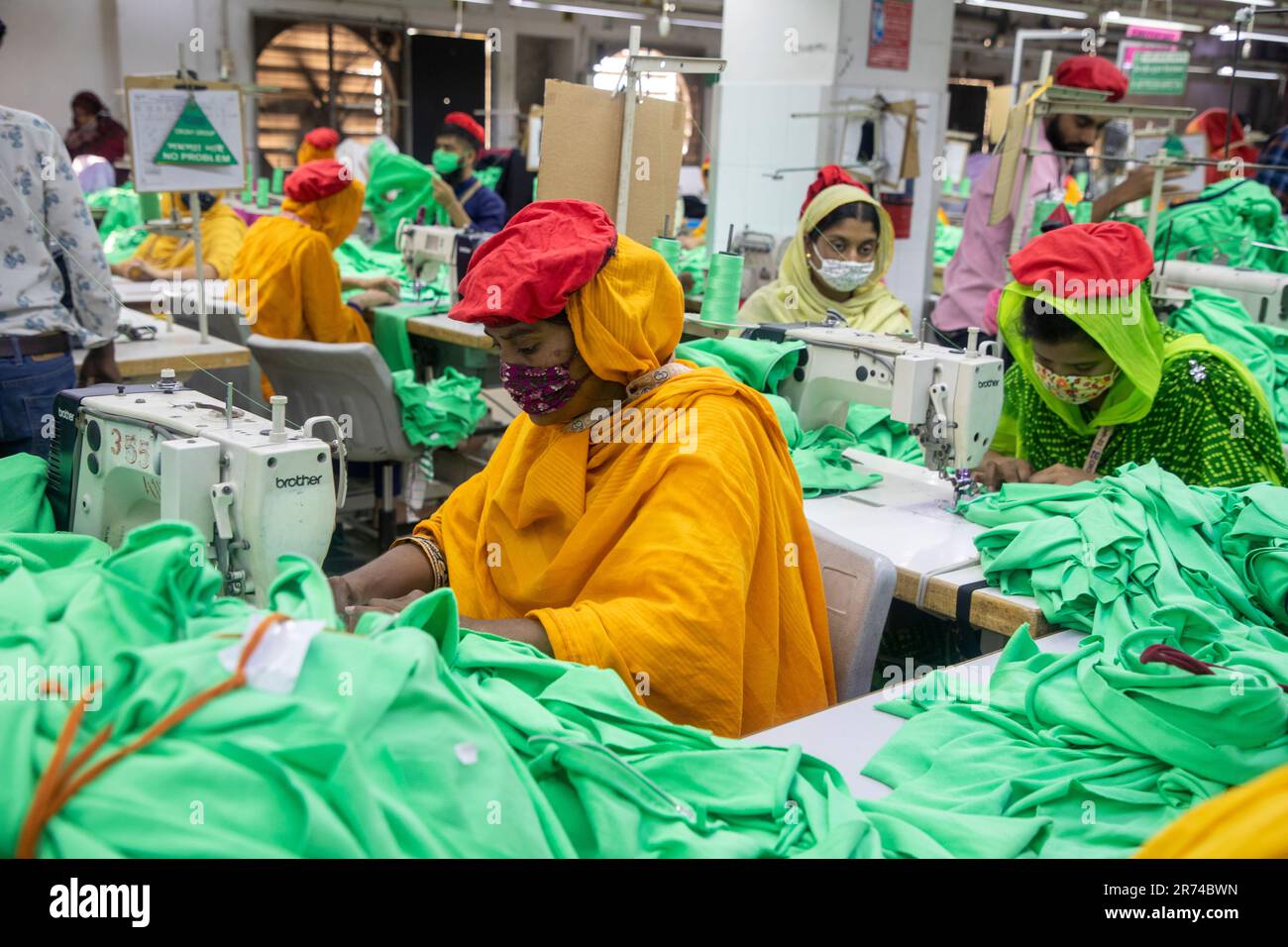 Ready-made garments (RMG) workers working in a factory at Fatullah in ...